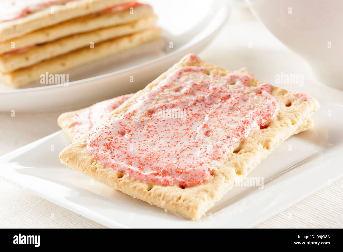 Hot Strawberry Toaster Pastry with frosting and sprinkles Stock Photo ...