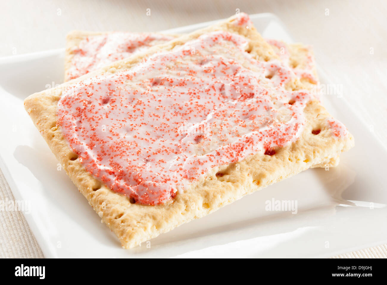 Hot Strawberry Toaster Pastry with frosting and sprinkles Stock Photo ...