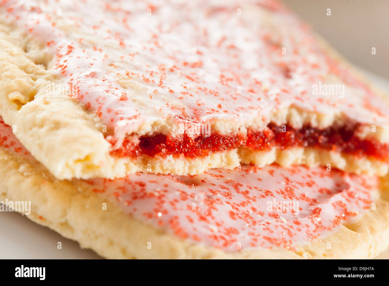 Hot Strawberry Toaster Pastry with frosting and sprinkles Stock Photo ...