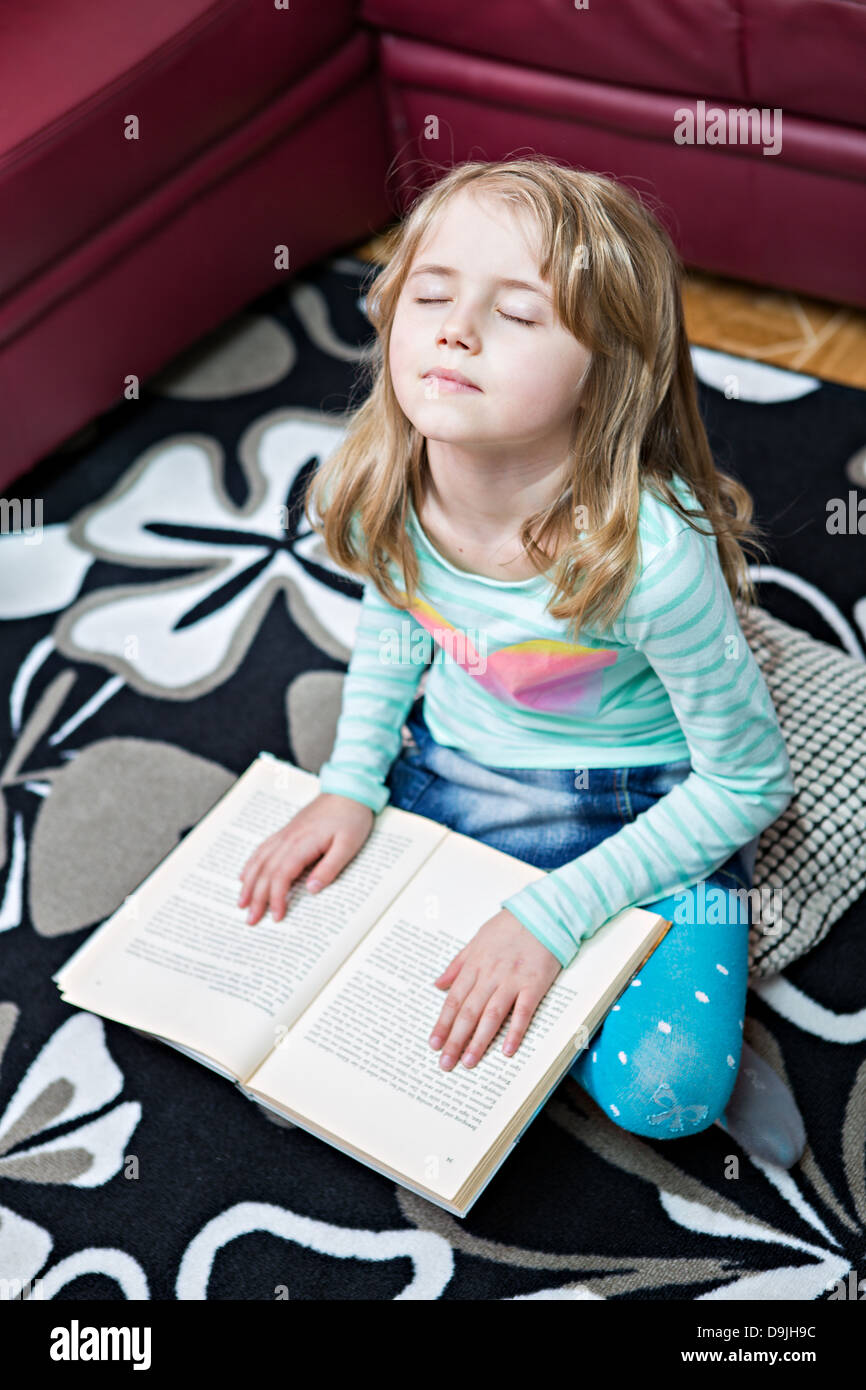 little girl reading a book at home Stock Photo - Alamy