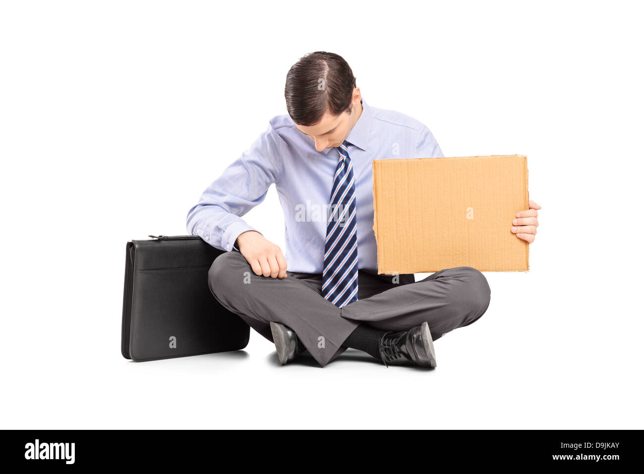 Bankrupted businessperson begging with a piece of cardboard Stock Photo ...
