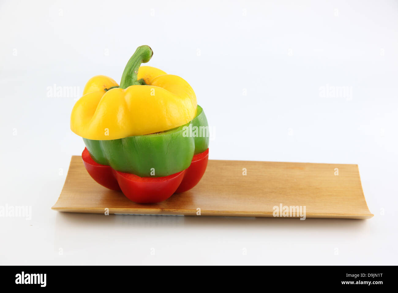 Three color of Sweet pepper Slice in the Bamboo dish on white ...