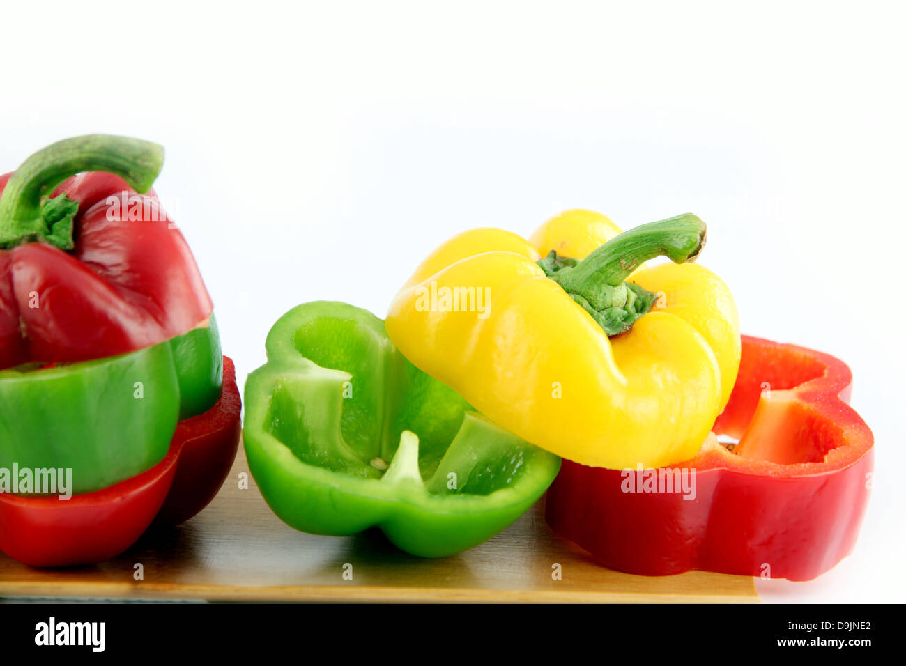 Zoom the Three color of bell pepper in the Bamboo dish on white ...