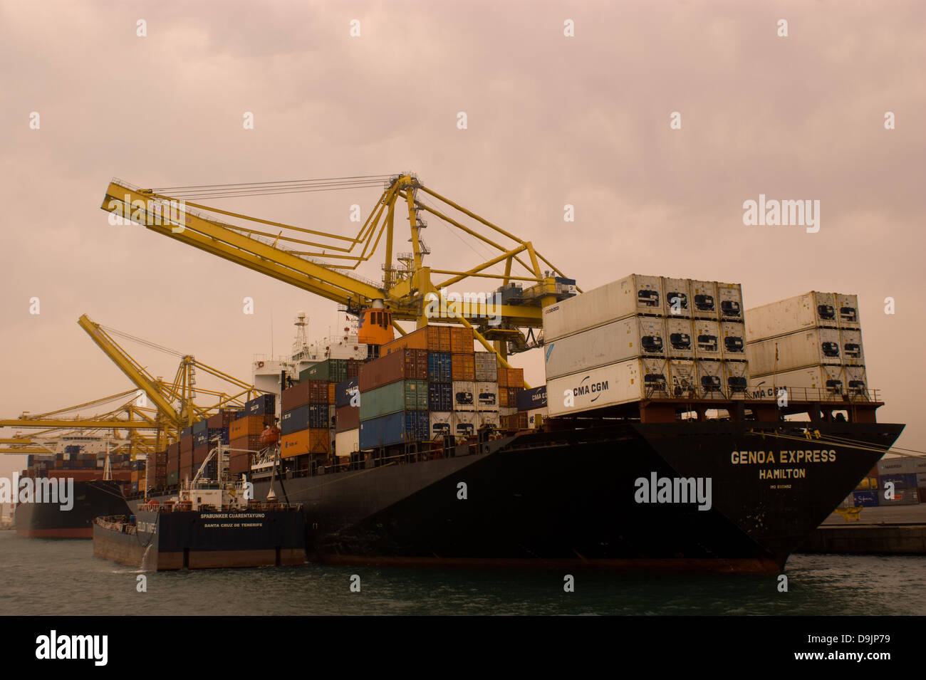 Large Container ship being loaded with containers by cranes in ...