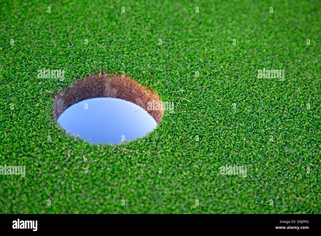 Golf hole on the green grass Stock Photo - Alamy
