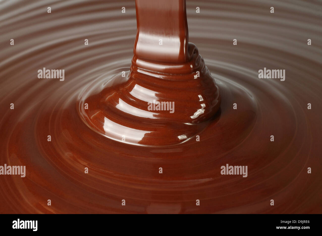 Dark chocolate flow close-up Stock Photo - Alamy
