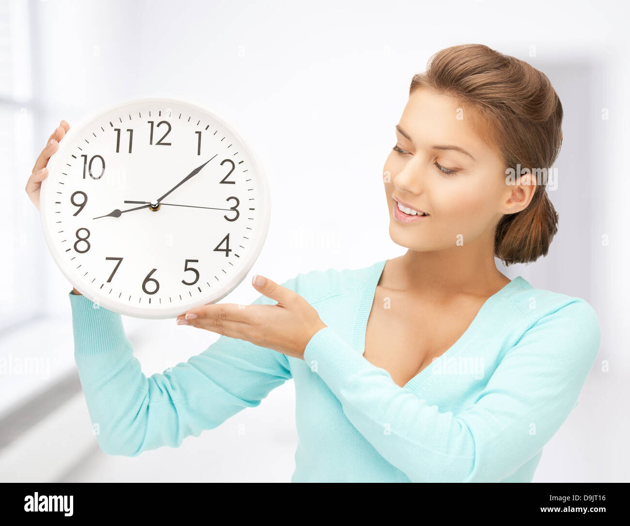 woman with wall clock Stock Photo - Alamy