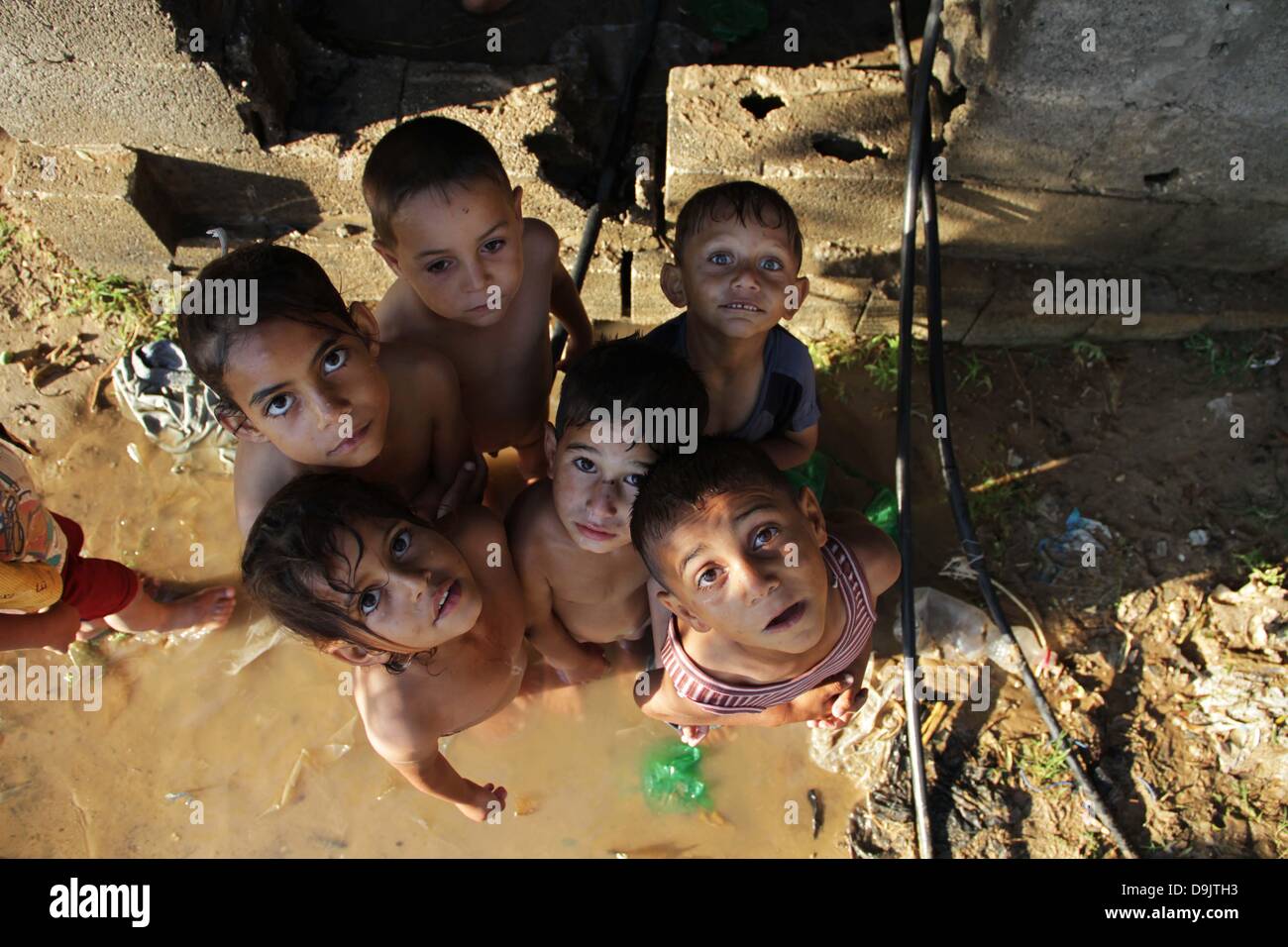 A group of children gather to take a picture after playing with water ...