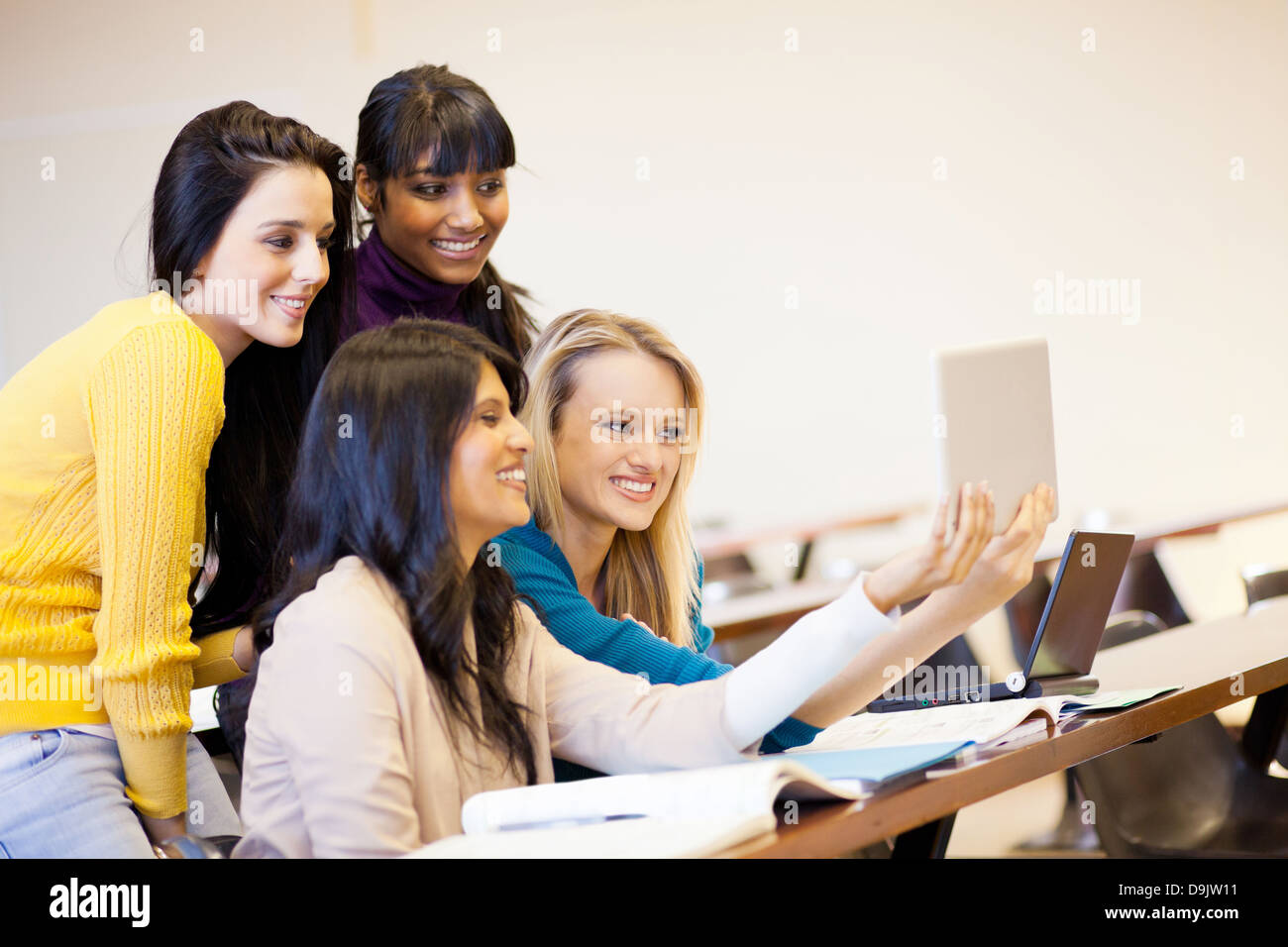 group of college students using tablet computer in classroom Stock ...