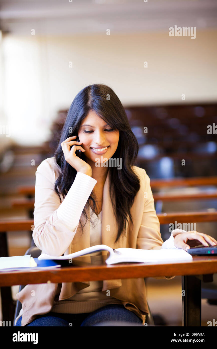female university student talking on cell phone in classroom Stock ...