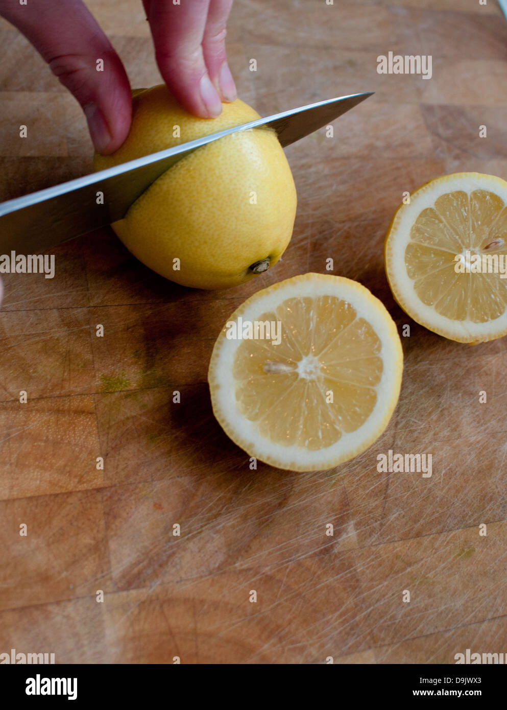 Knife slicing lemons hi-res stock photography and images - Alamy