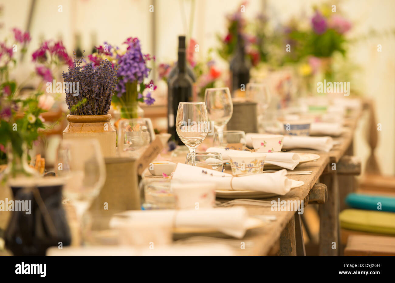A large table set for a meal using a vintage theme Stock Photo - Alamy