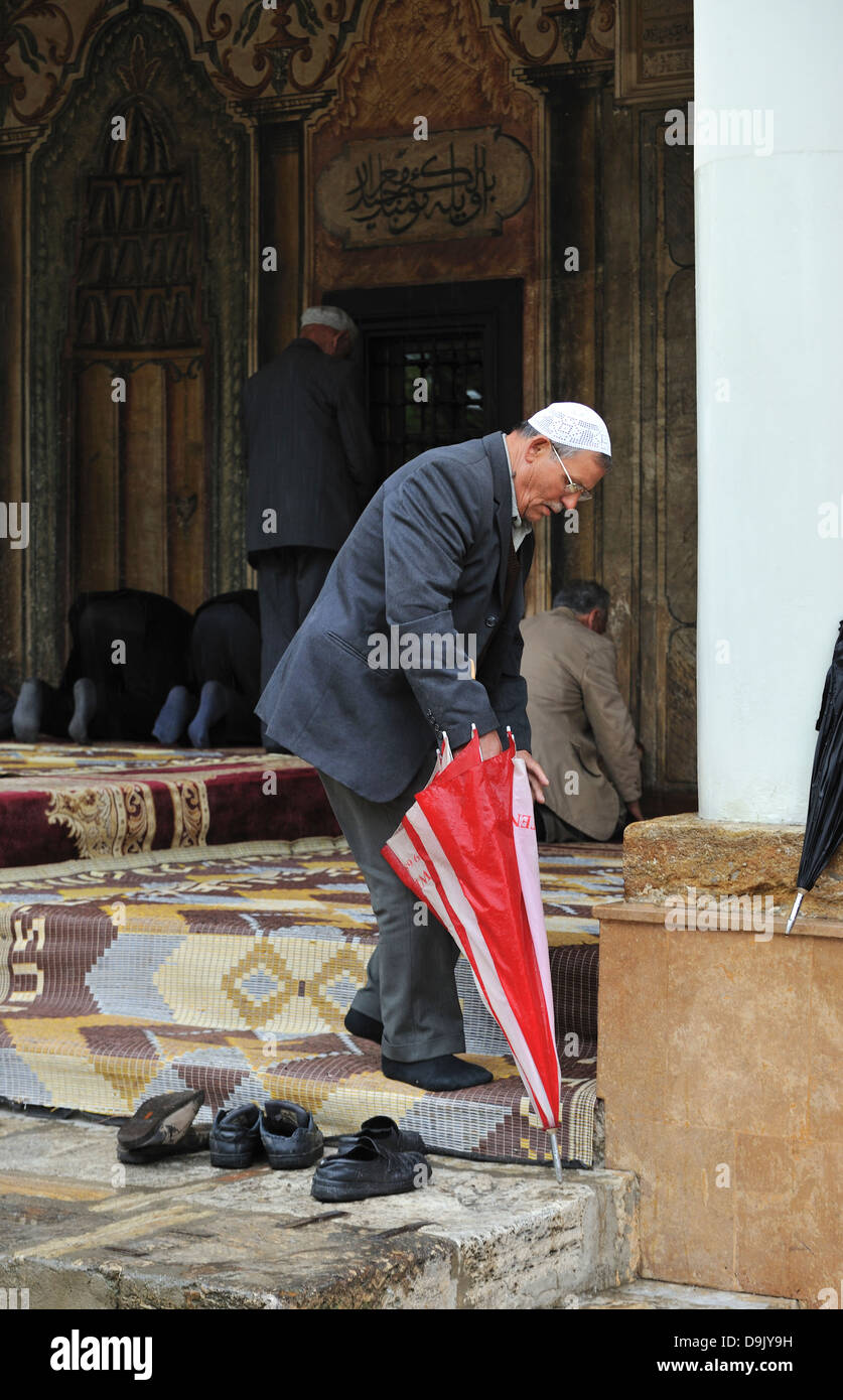 Man take his shoes off before entering a mosque, Painted Mosque (Sarena ...