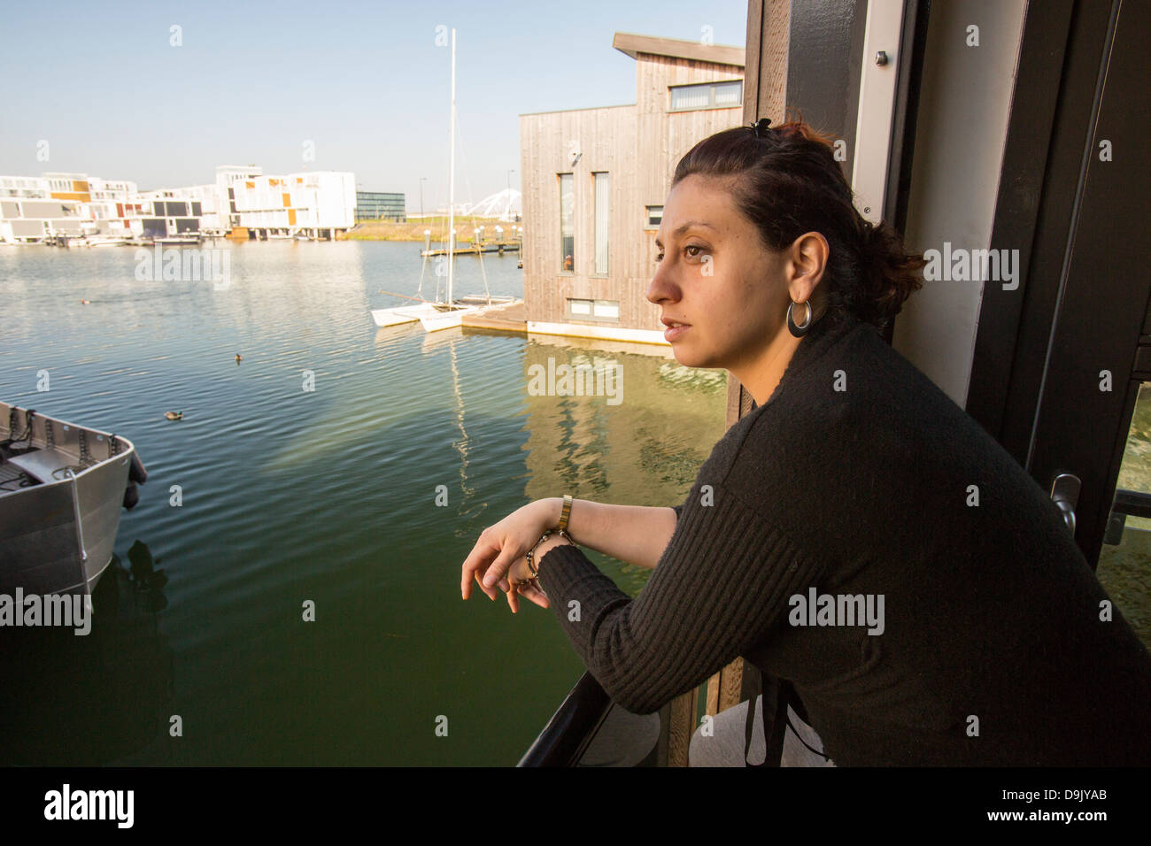 A woman in her floating house in Ijburg, Amsterdam, built to combat sea ...