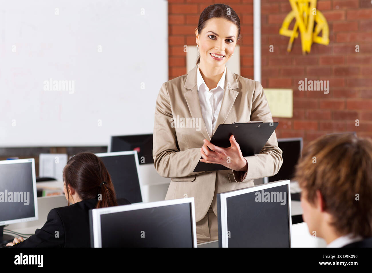 pretty female high school teacher portrait in computer room Stock Photo ...