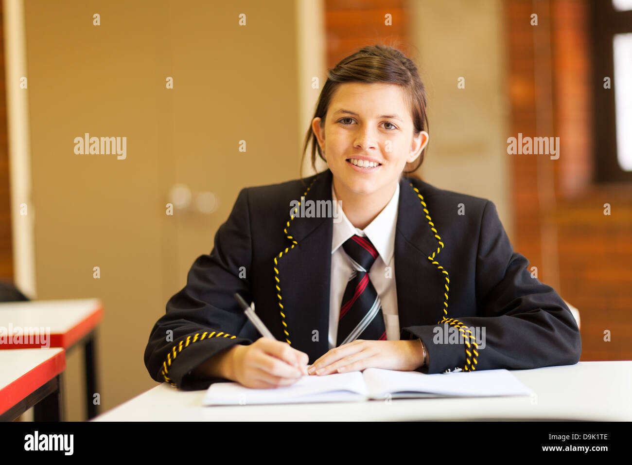 pretty middle school girl sitting in classroom Stock Photo - Alamy