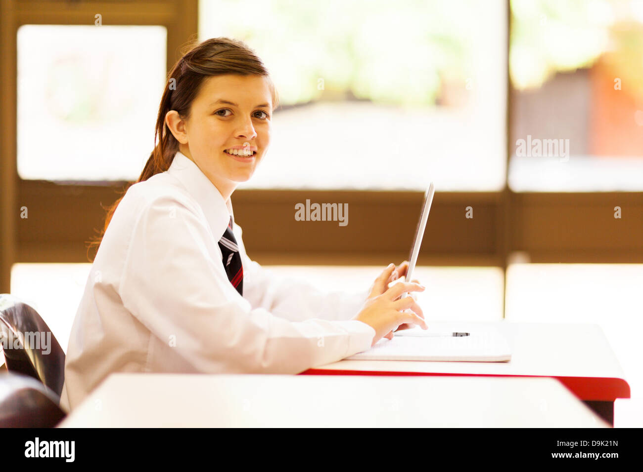 female middle school student using tablet computer in classroom Stock ...