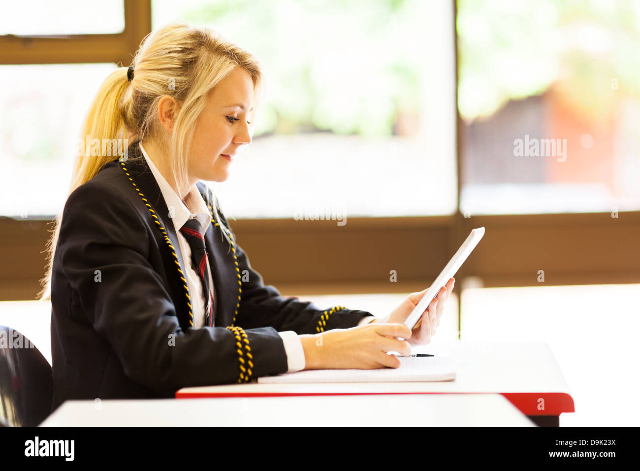 cute high school girl using tablet computer in classroom Stock Photo ...