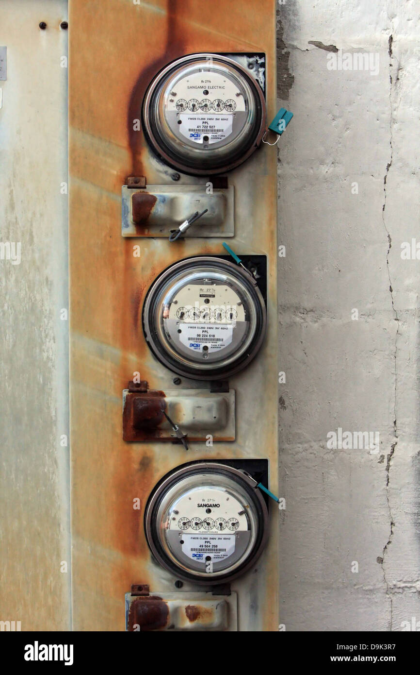 three electric electrical meter meters rust rusty rusted wall power ...