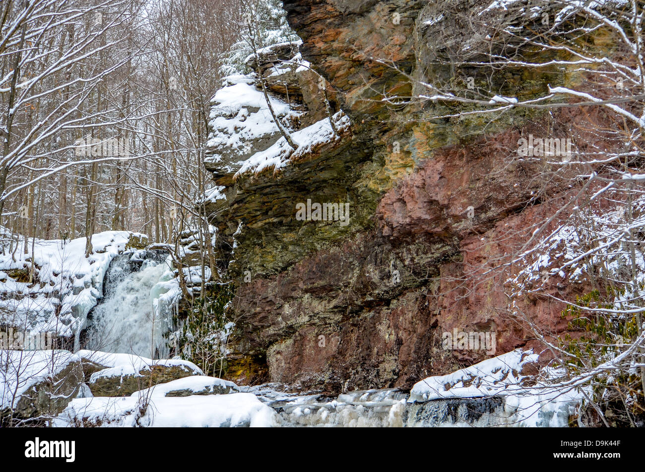 Rock outcropping above a small winter waterfall Stock Photo - Alamy
