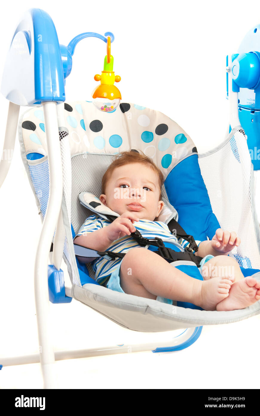 Baby boy in electrical swing isolated on white background Stock Photo ...