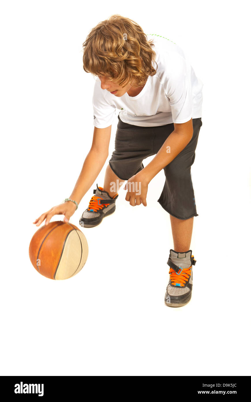 Teenager boy dribbling basketball isolated on white background Stock ...