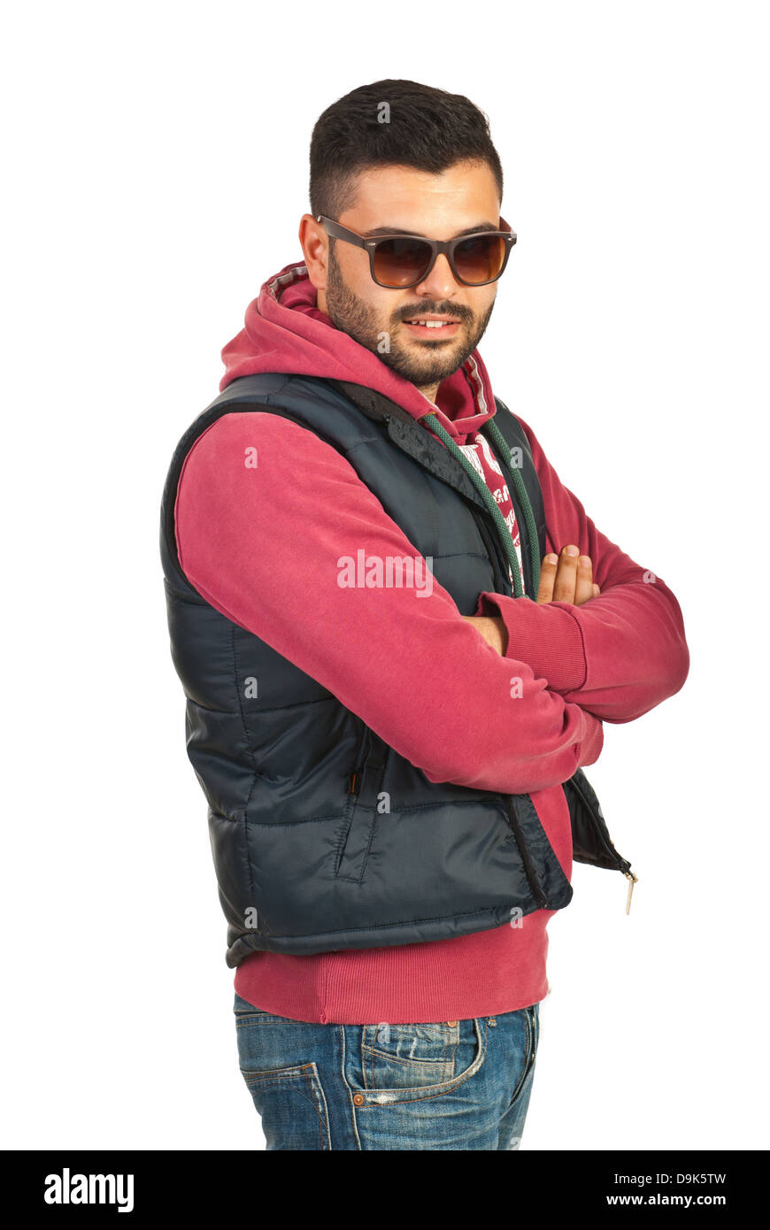 Urban trendy man standing in semi profile with arms folded isolated on ...