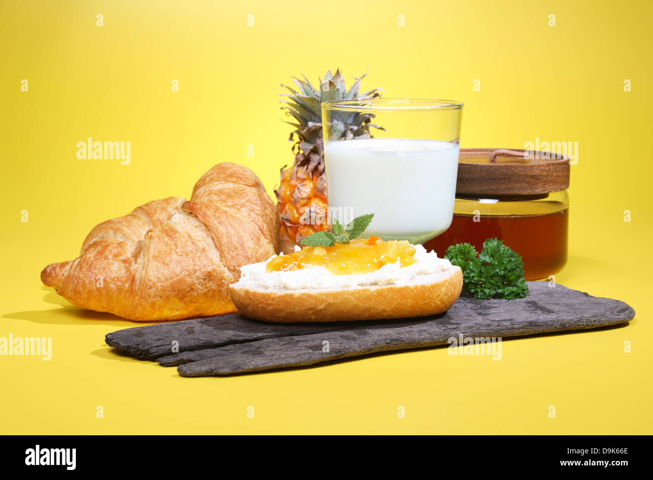 Breakfast with cream cheese, honey and milk Stock Photo - Alamy