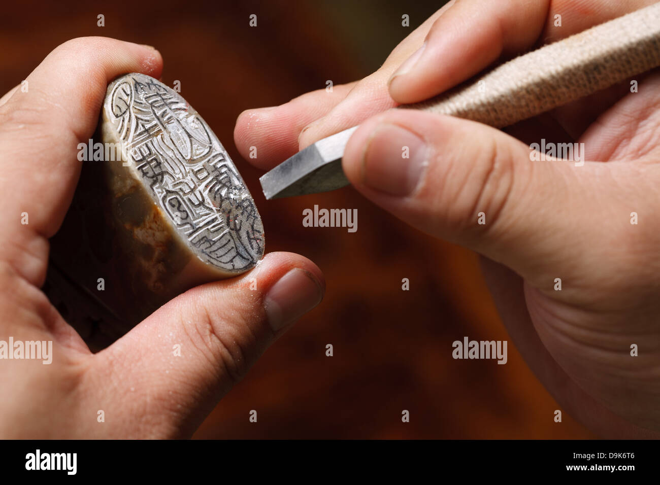 Craftsman carving Chinese character into a Chinese chop Stock Photo - Alamy