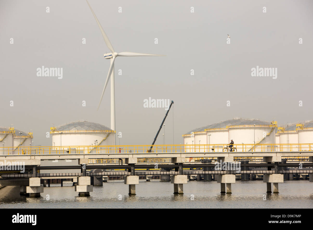 Climate change heaven and hell, oil storage tanks and wind turbines on ...