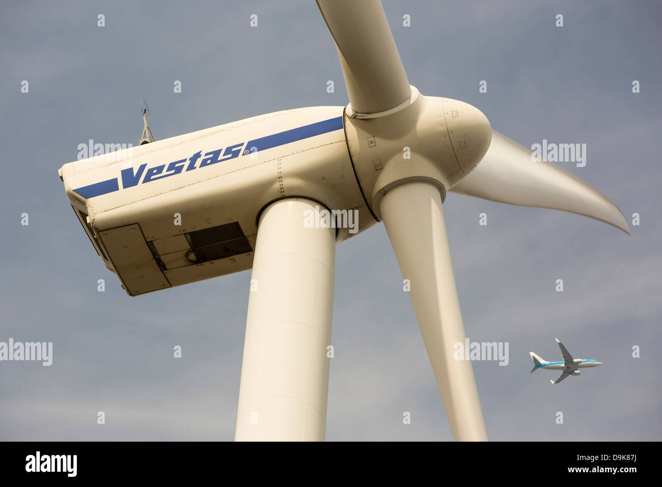 A plane flying past a wind turbine in Amsterdam, Netherlands Stock ...