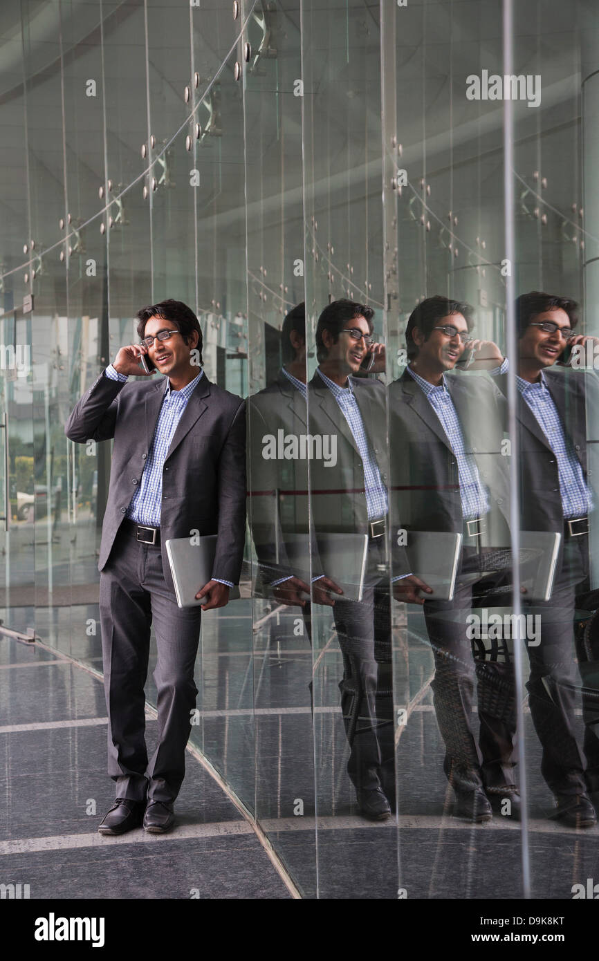 Reflection of a businessman talking on a mobile phone Stock Photo - Alamy