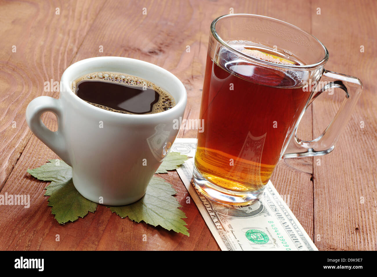 Cup of Coffee, tea and one dollar on a wooden table Stock Photo - Alamy