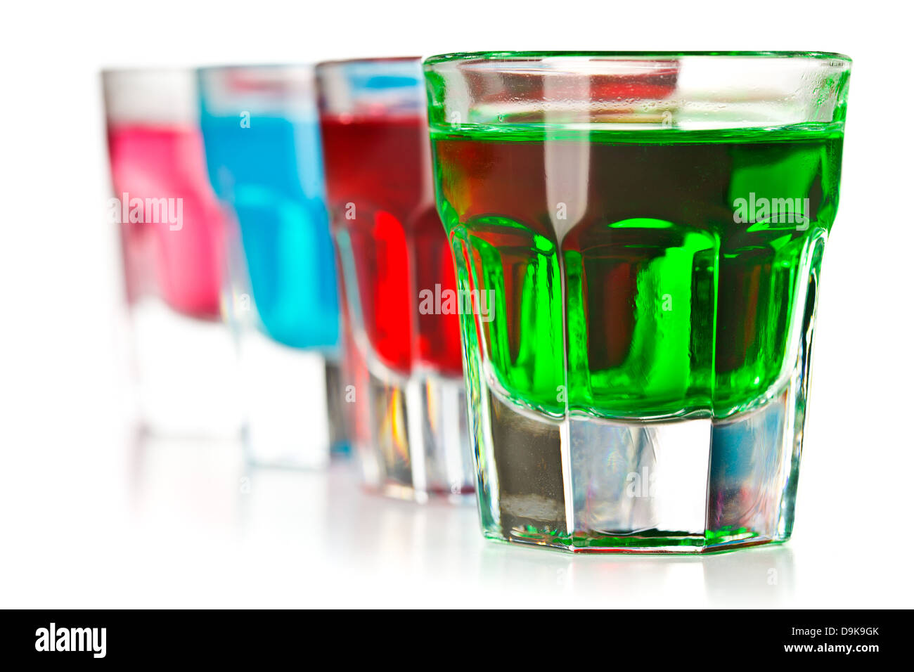 the various colorful liquors on white background Stock Photo - Alamy