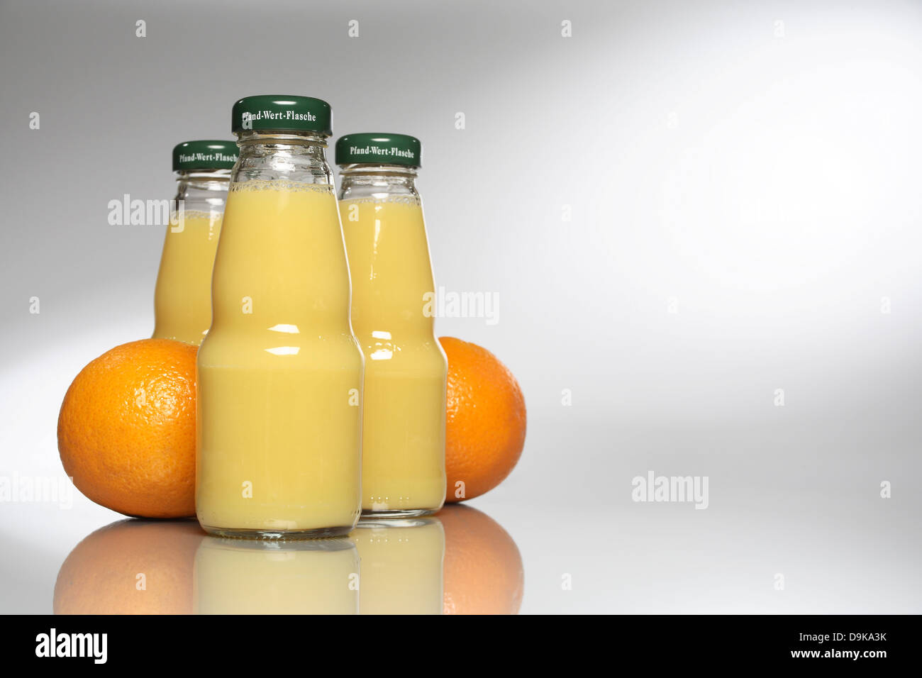 Bottles with orange juice Stock Photo - Alamy