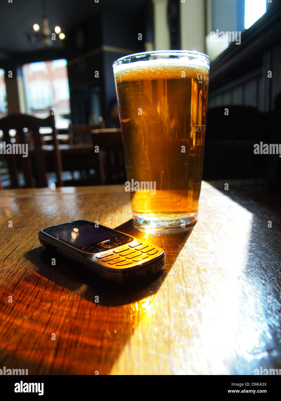 A pint of beer with mobile phone Stock Photo - Alamy