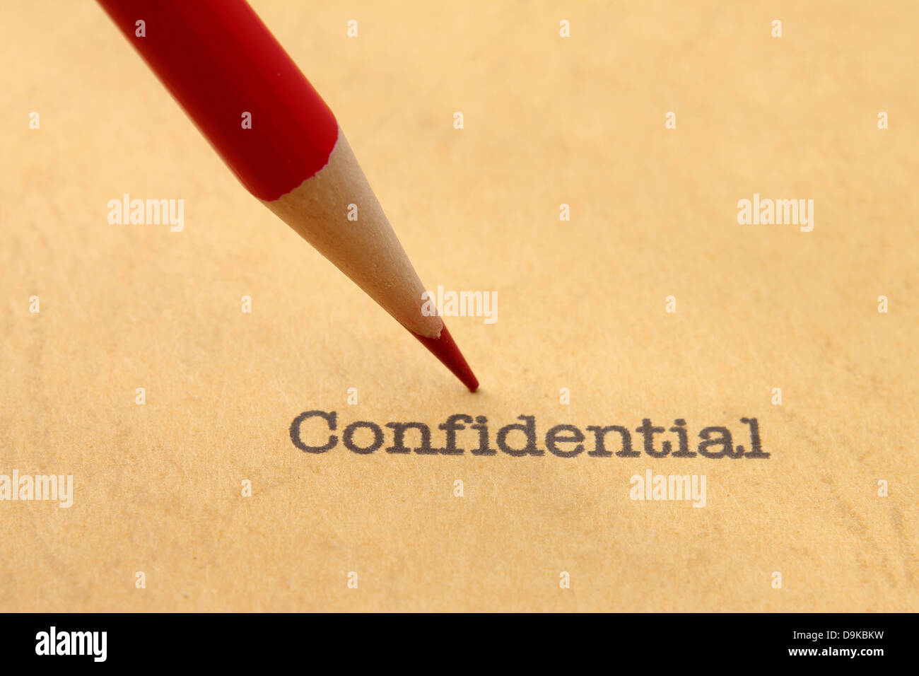Confidential text on paper with pencil Stock Photo - Alamy