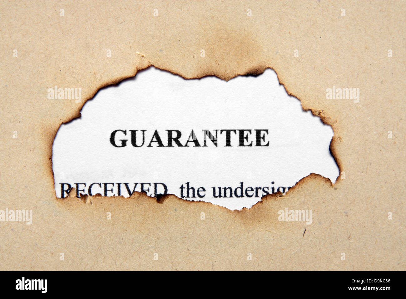 Guarantee text in paper hole Stock Photo - Alamy