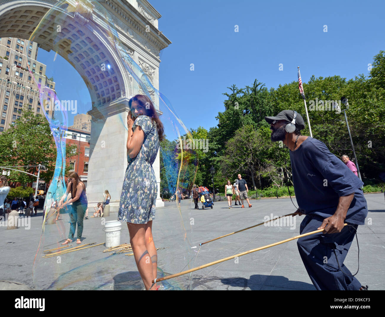 Man in Washington Square Park in New York City making a large bubble ...