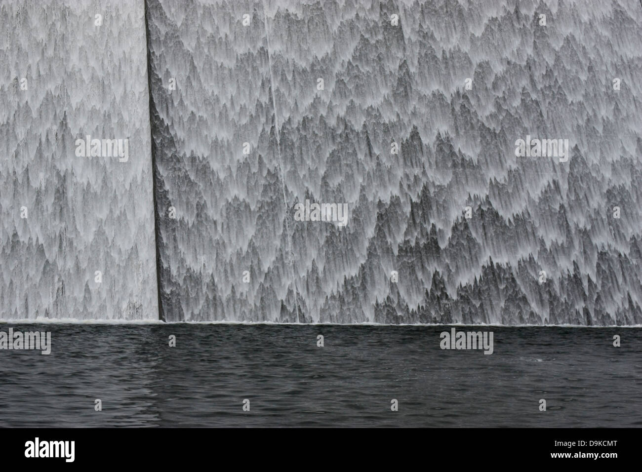 Water falling down dam into pool Stock Photo - Alamy