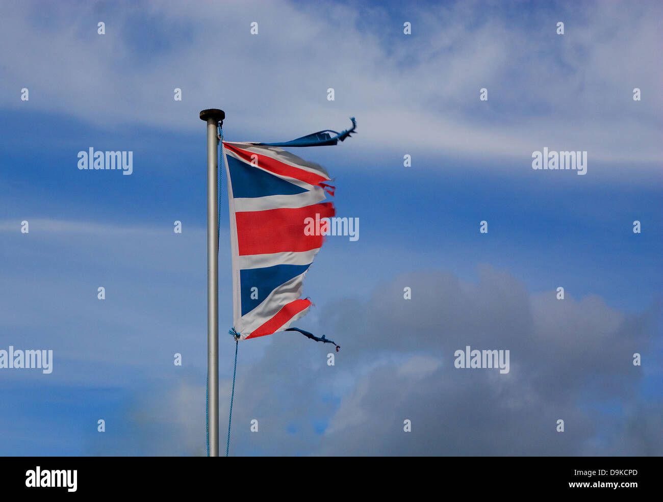 Ragged union jack blowing in strong wind Stock Photo - Alamy