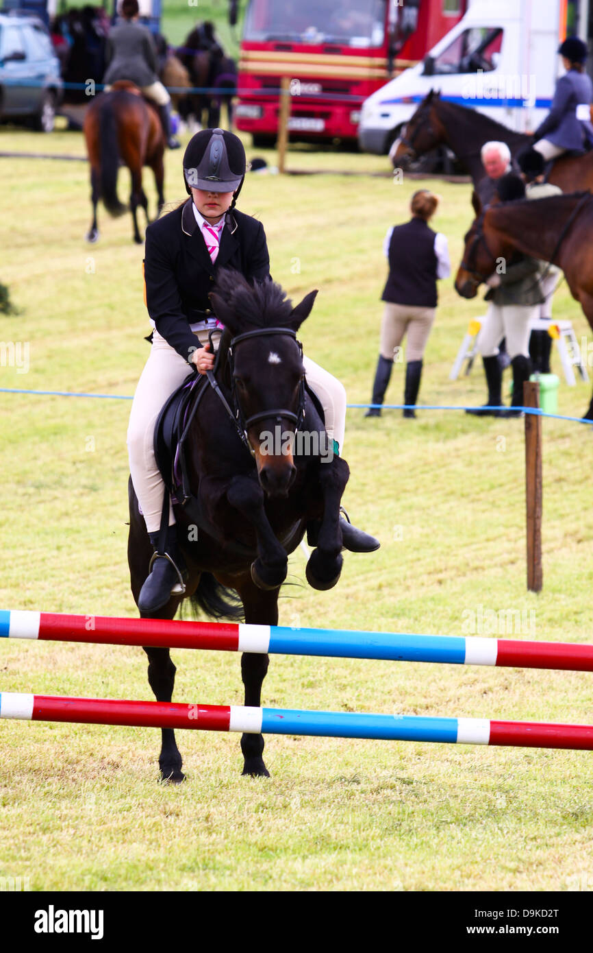 Young girl jumping pony at local horse show Stock Photo - Alamy