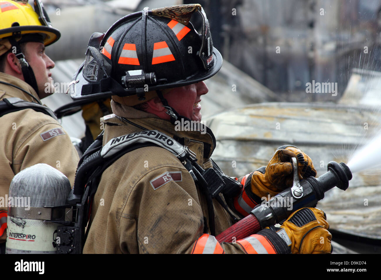 Firemen using hose hi-res stock photography and images - Alamy