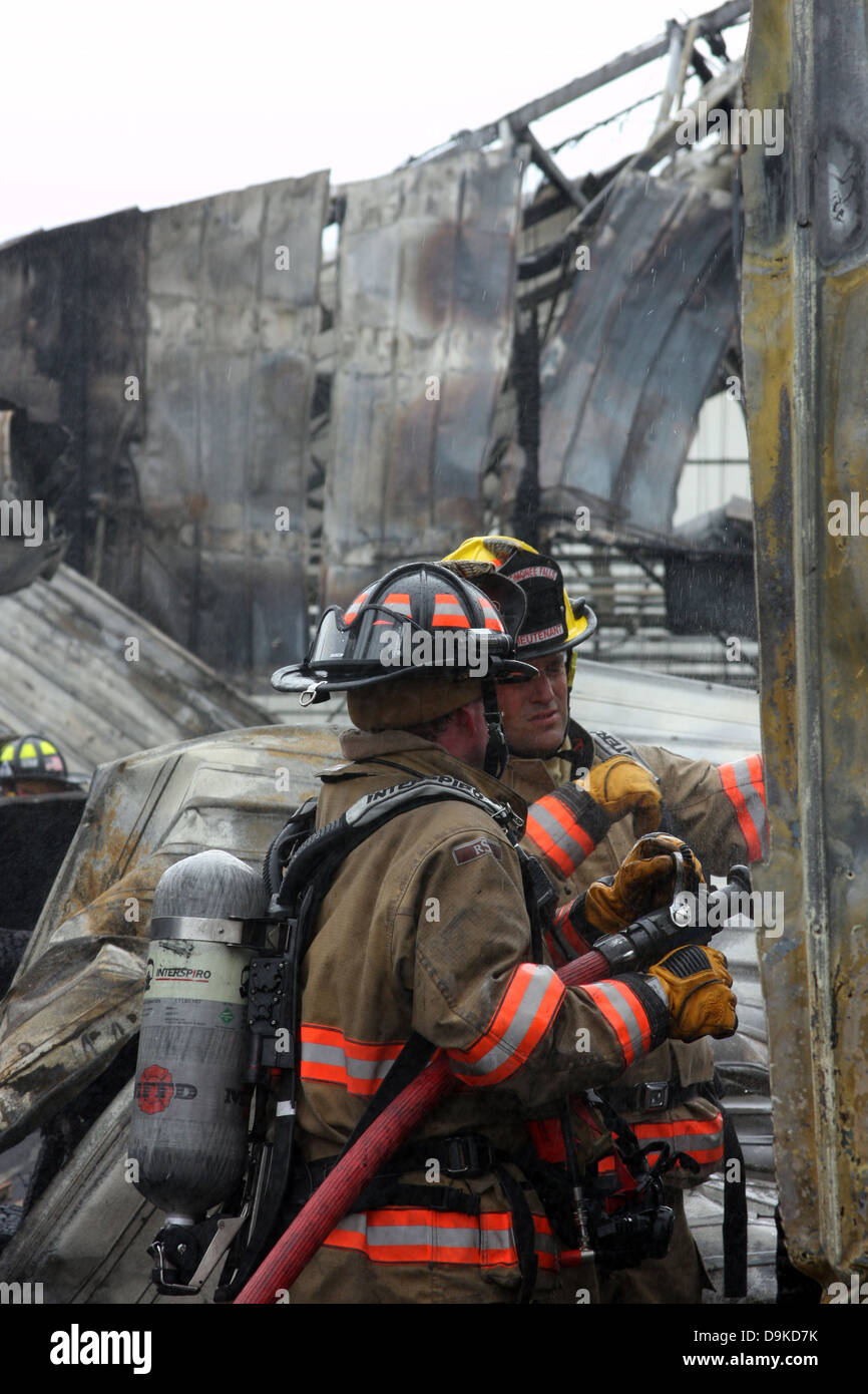 Group firefighters extinguishing burning hi-res stock photography and ...