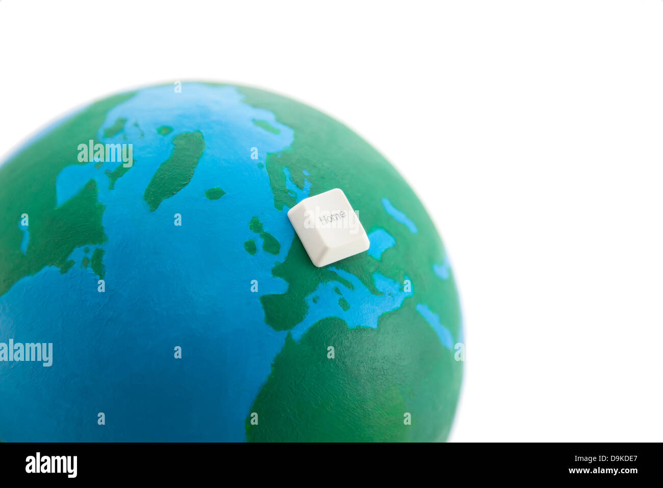 Home computer key on an earth globe isolated on white Stock Photo - Alamy