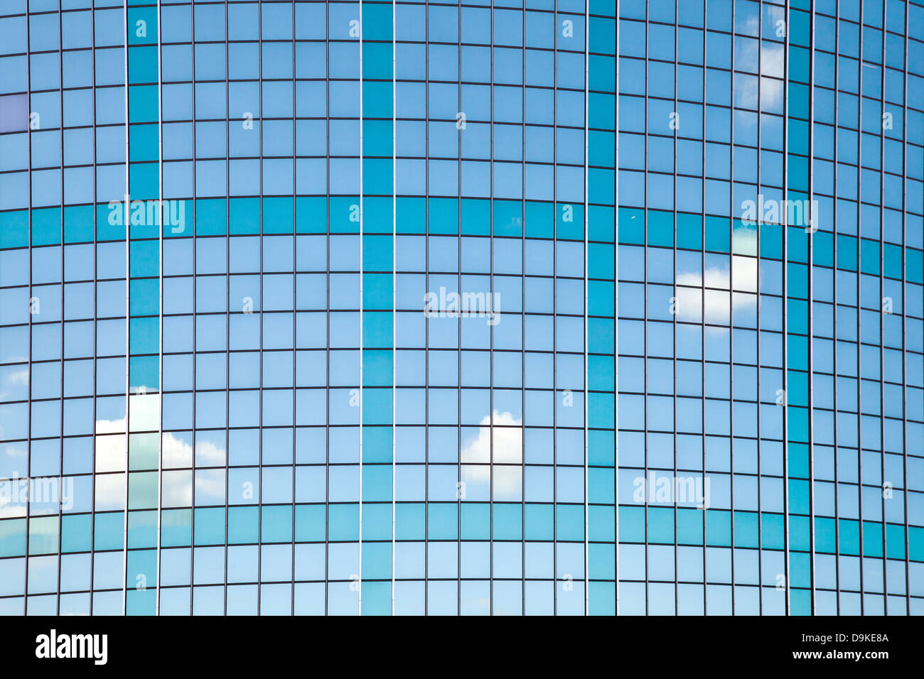 curved facade with reflections of sky and clouds in trade building in ...