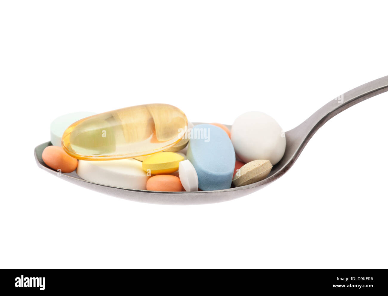 Pills on spoon with clipping path Stock Photo - Alamy