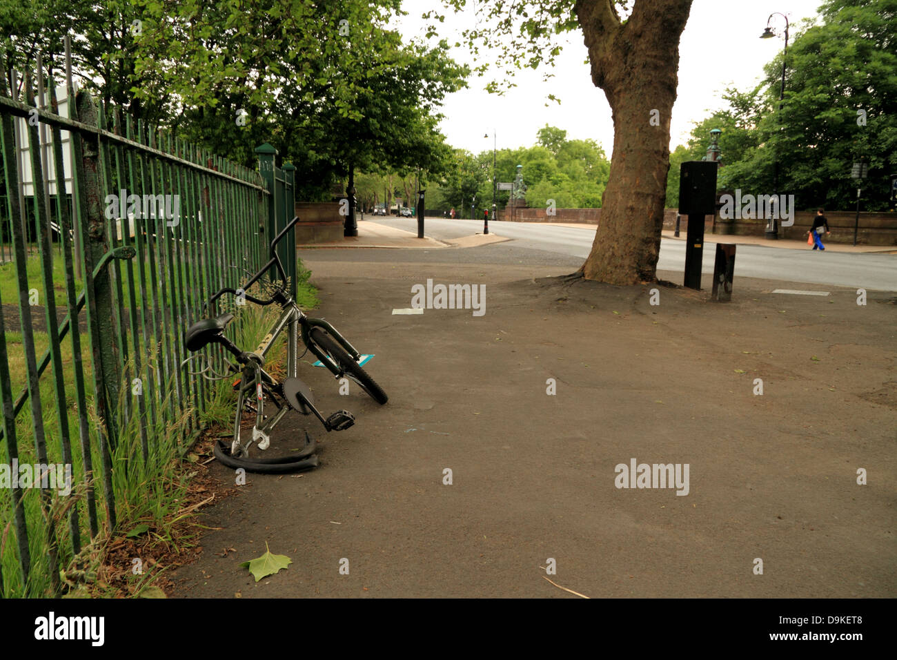 A broken bicycle lays ripped apart locked to the railings, in Glasgow ...