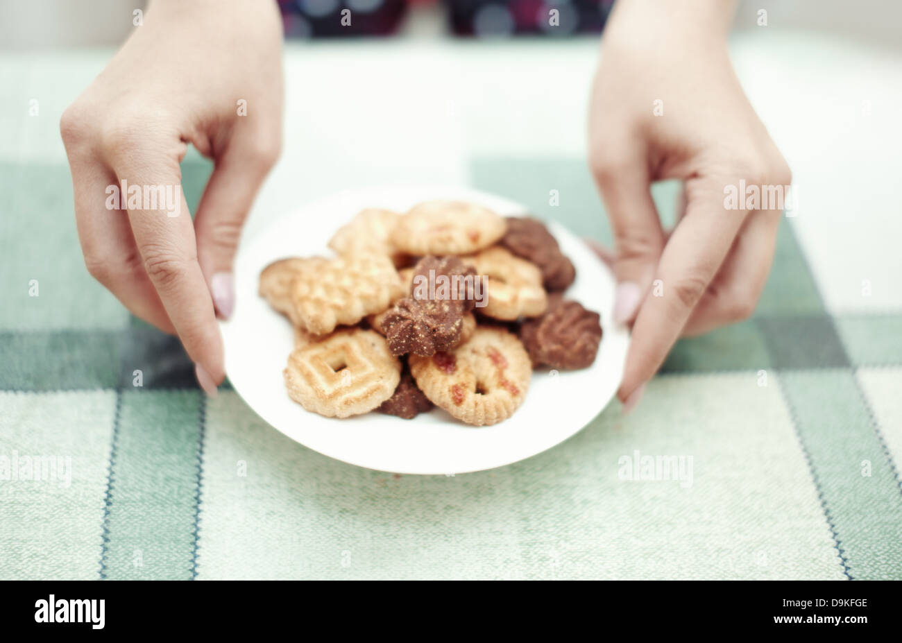 Human hands putting plate with cookies to the table Stock Photo - Alamy