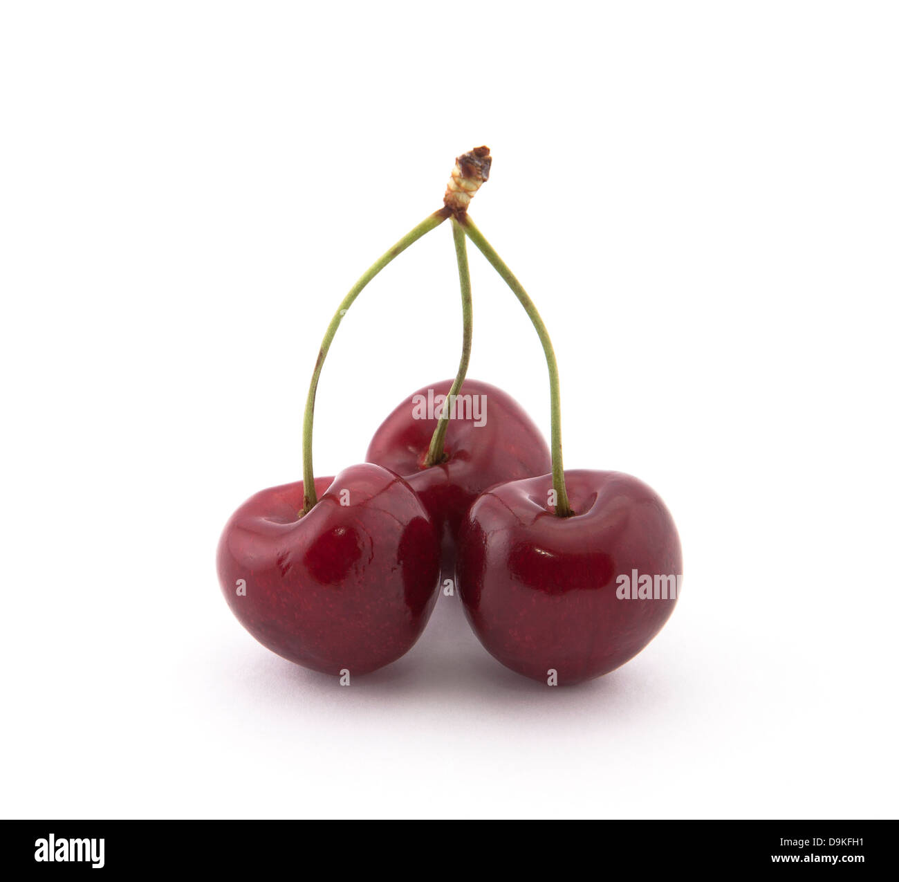 Three cherries over white background Stock Photo - Alamy